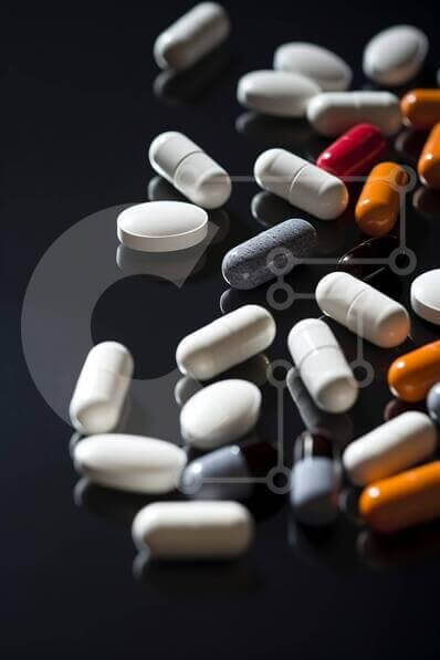 Colorful Pill Capsules Scattered on Black Background stock photo ...