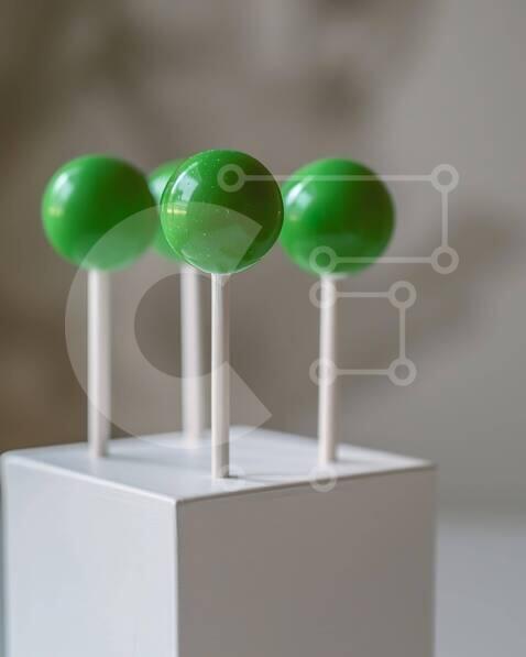 Delicious Green Lollipops on White Cube with Candies stock photo ...