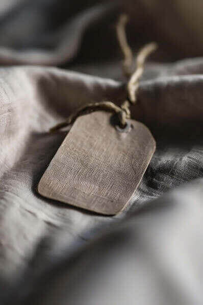 Download Brown Identification Tag on Fabric Background Mockups Online ...