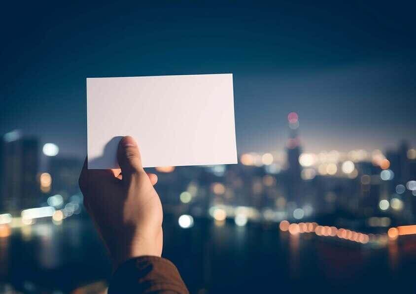 Download Hand holding empty paper in front of city skyline at night ...