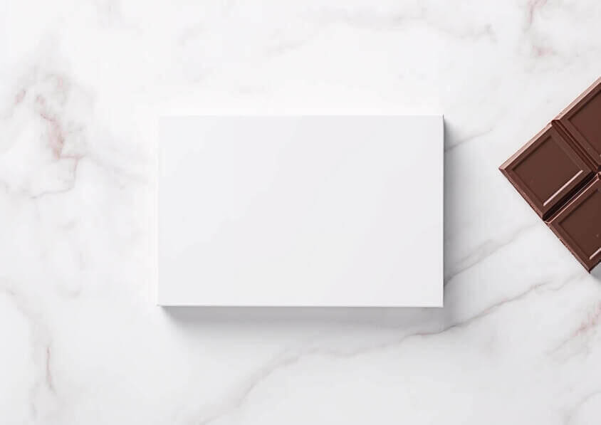 Download White Chocolate Bar and Empty Cardboard Box on Marble Tabletop ...