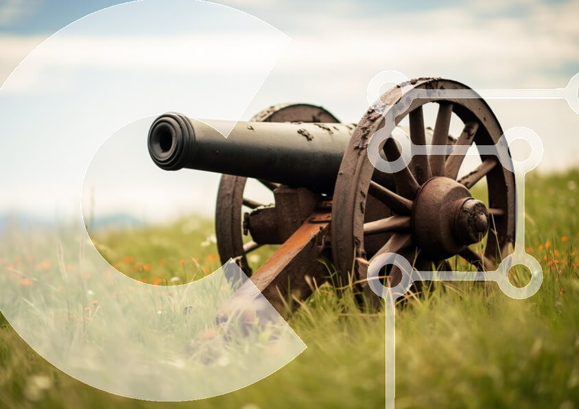 Vintage Cannon in Grassy Field with Flowers stock photo | Creative Fabrica