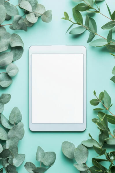 Download Tablet Surrounded by Eucalyptus Leaves on a Mint Green ...