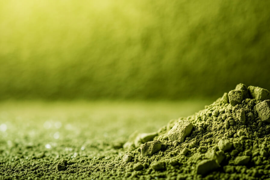 Download Green Powder on Textured Surface with Yellowish Background ...